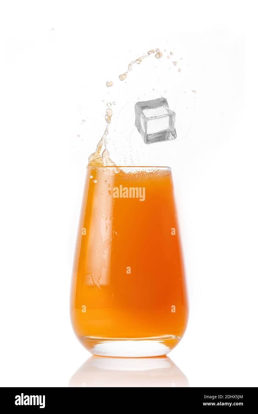 Glass of fruit juice with ice on a white background Stock Photo - Alamy
