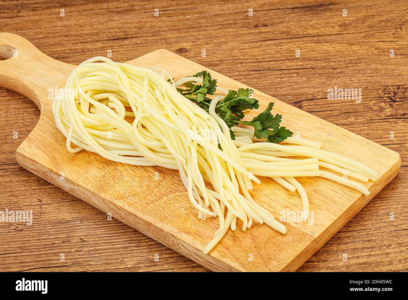 Chechil spaghetti cheese snack over board Stock Photo - Alamy