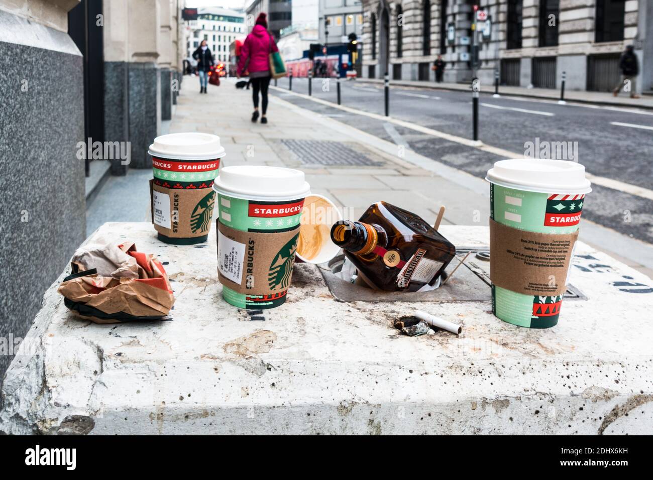 Coffee cups, alcohol bottle and litter left on pavement Stock Photo - Alamy