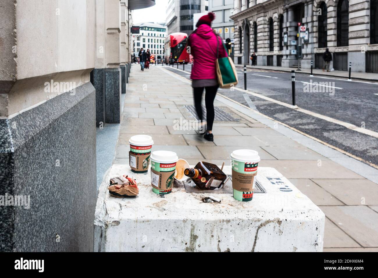 Coffee cups, alcohol bottle and litter left on pavement Stock Photo - Alamy
