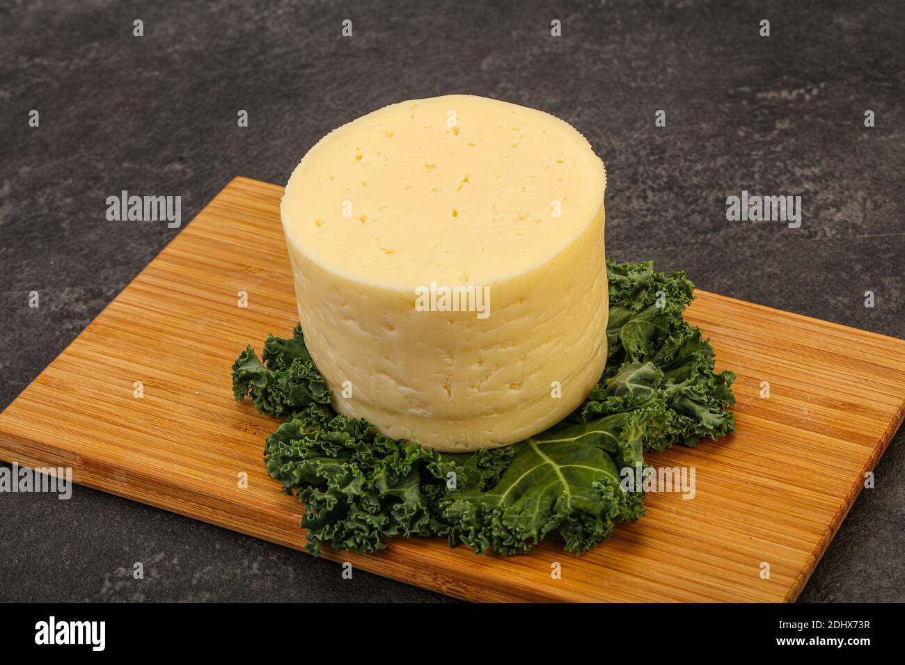 Yellow round dairy soft cheese piece Stock Photo - Alamy