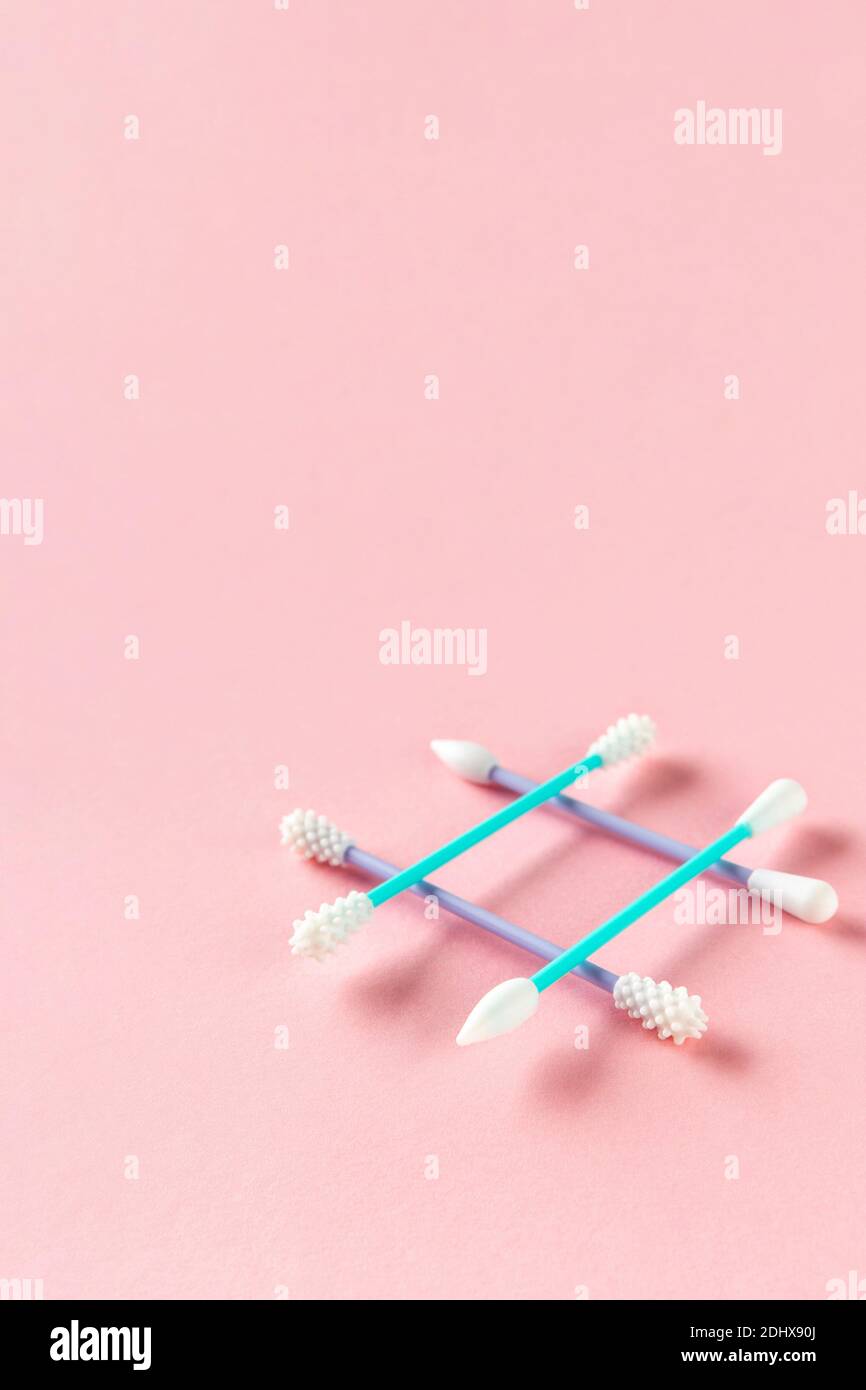 Reusable silicone swab on pink background. Alternative to cotton buds ...