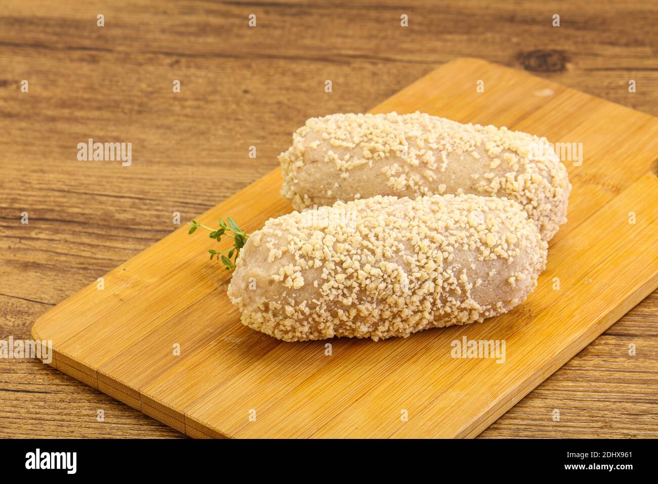 Raw breaded chicken cutlet for roast Stock Photo - Alamy