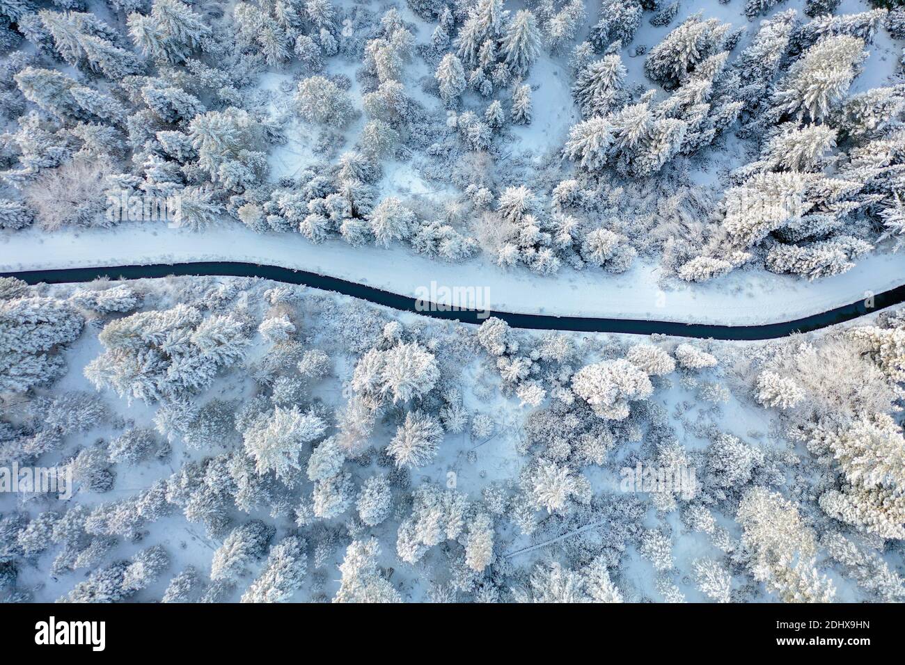 Narrow channel in the middle of a snowy forest Stock Photo - Alamy
