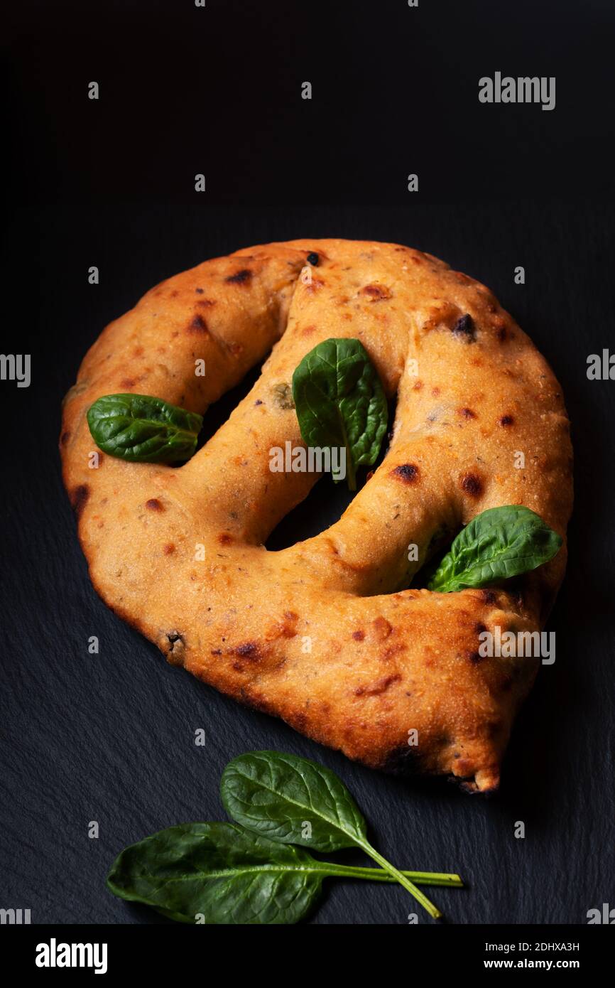 Food concept traditoin French Fougasse artisan flatbread on black slate ...