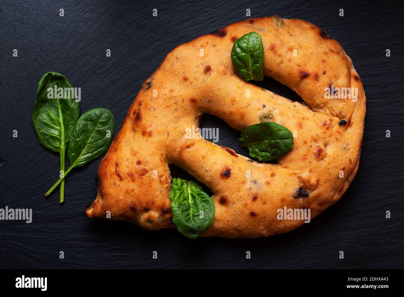 Food concept traditoin French Fougasse artisan flatbread on black slate ...
