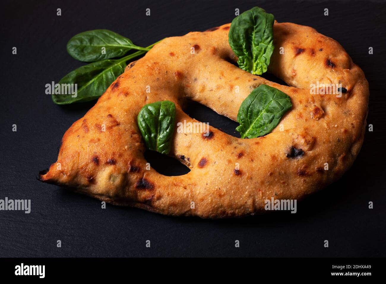 Food concept traditoin French Fougasse artisan flatbread on black slate ...