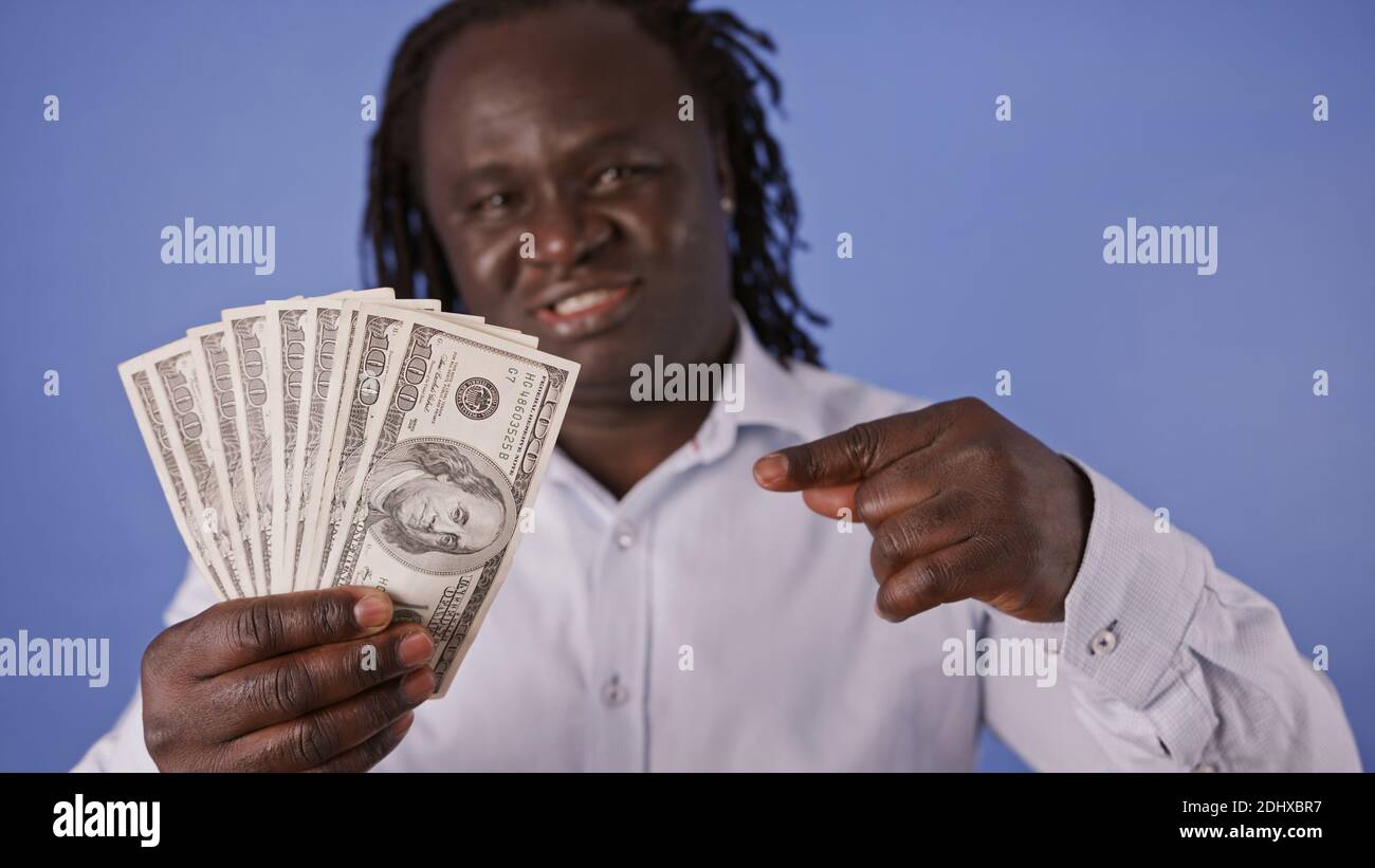 Rich african american black man pointing finger on the money fan. High ...