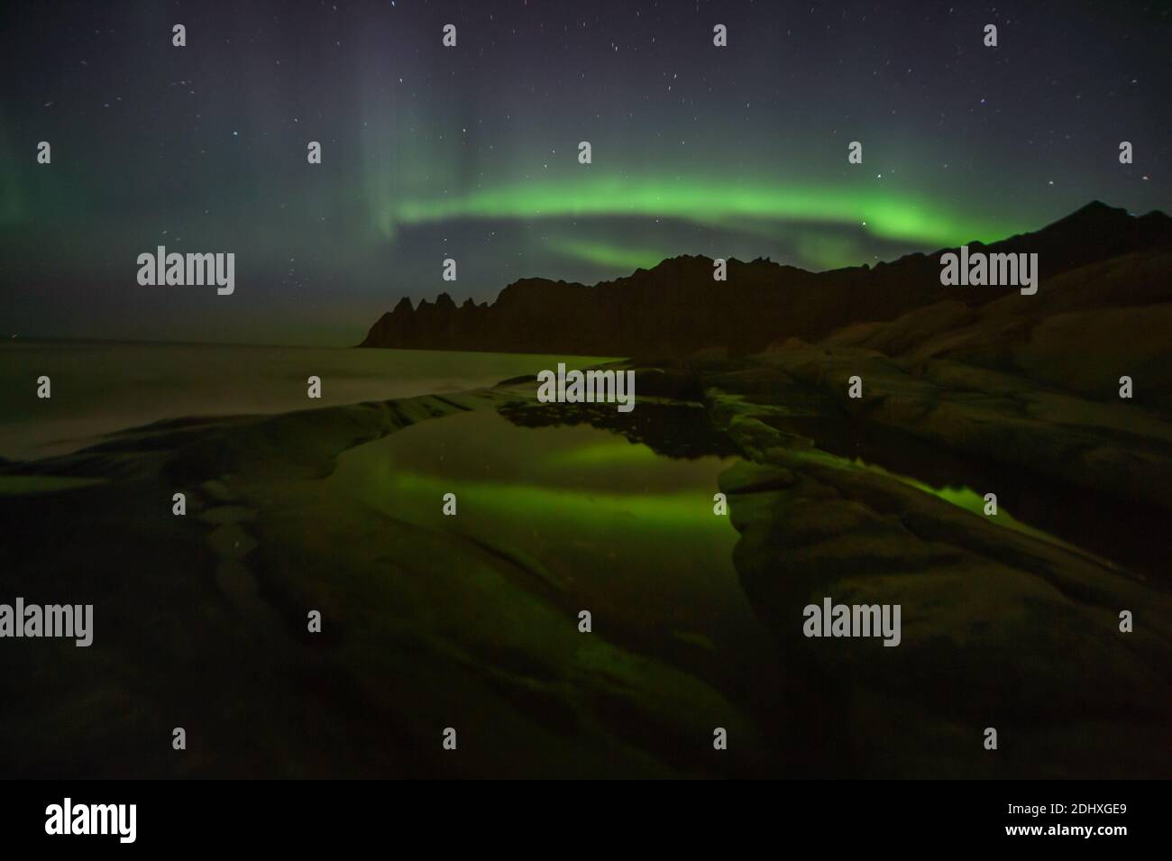 Northern lights reflected on the sea on a cold night in norway Stock ...