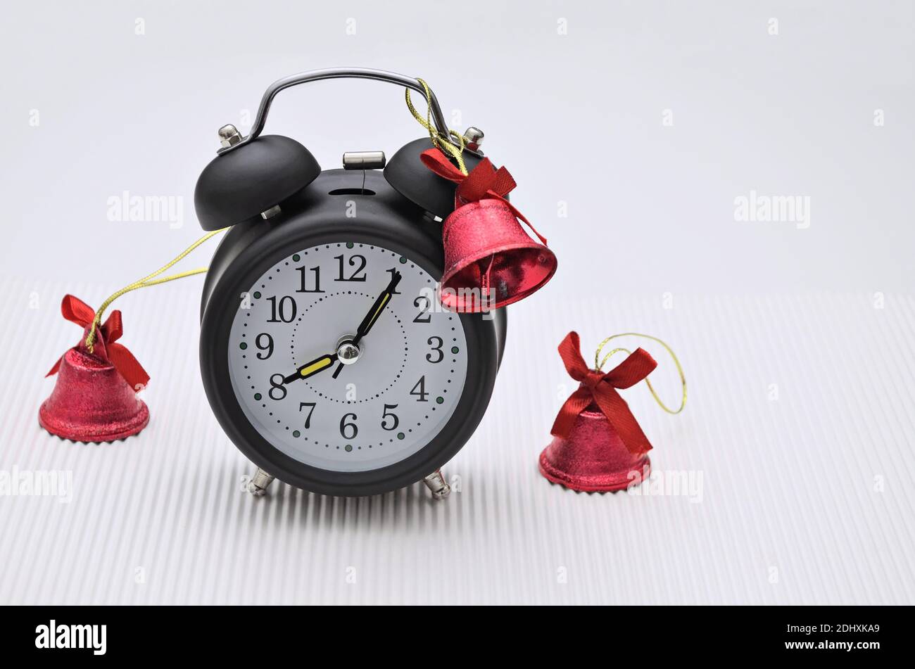 close up of a black retro alarm clock with three red bells, isolated on ...