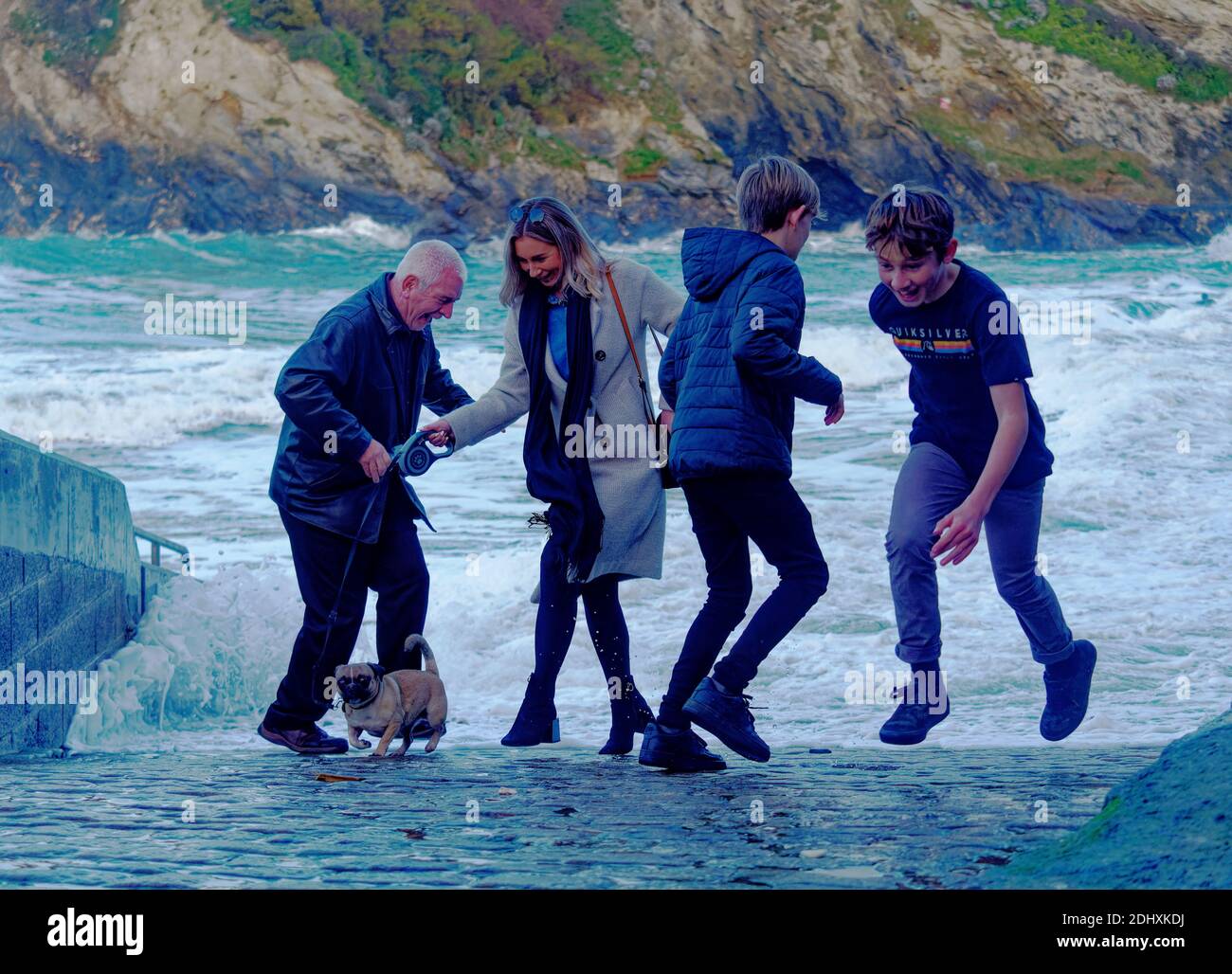 Family chased by waves hi-res stock photography and images - Alamy