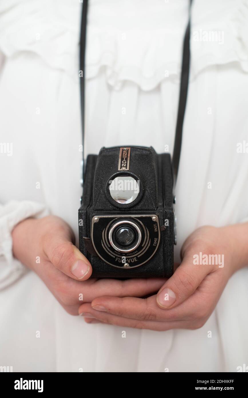 Old analog camera from the 50s in the hands of a girl Stock Photo - Alamy