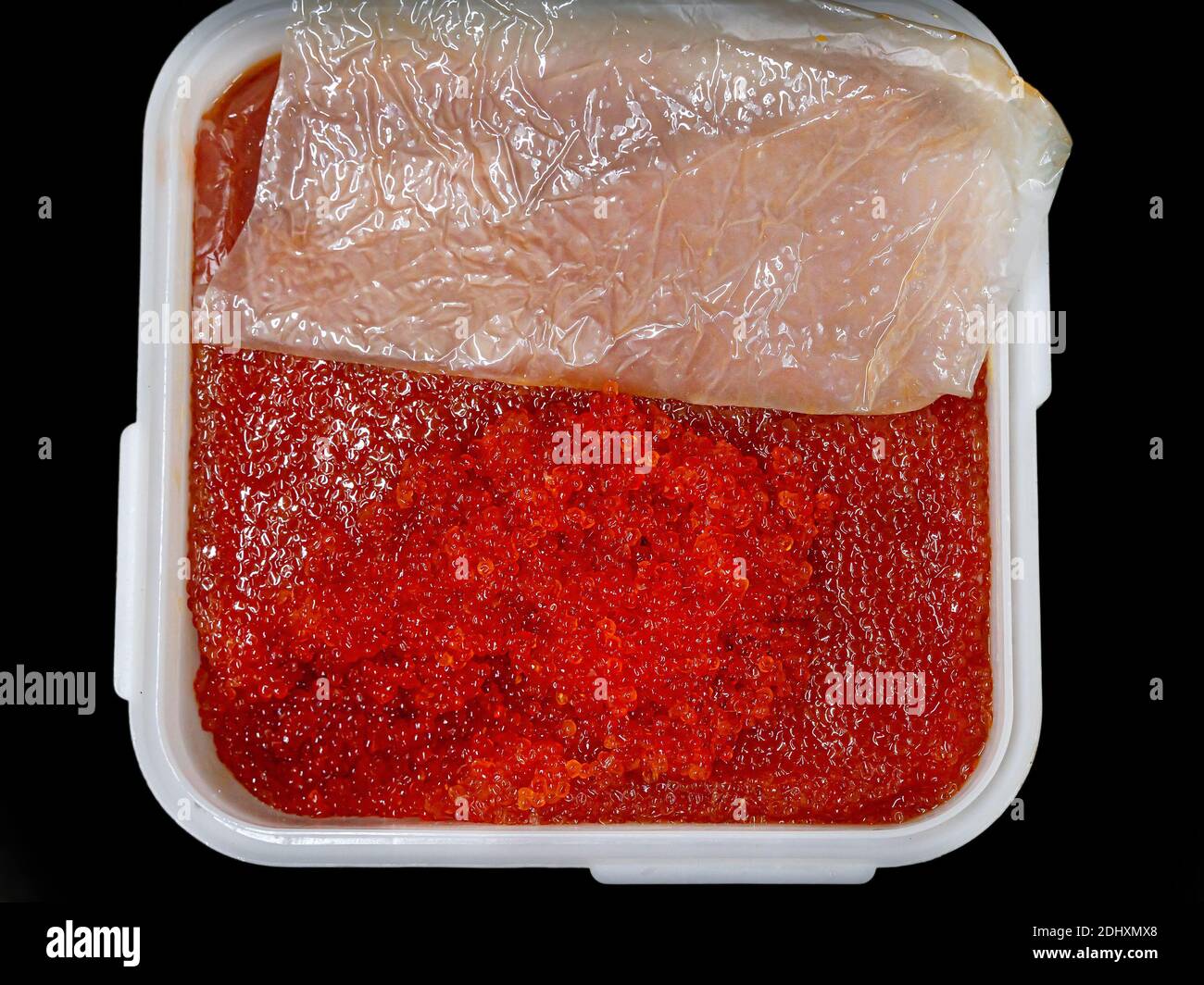 Red caviar background. Caviar in a big plastic container. Salmon roe ...