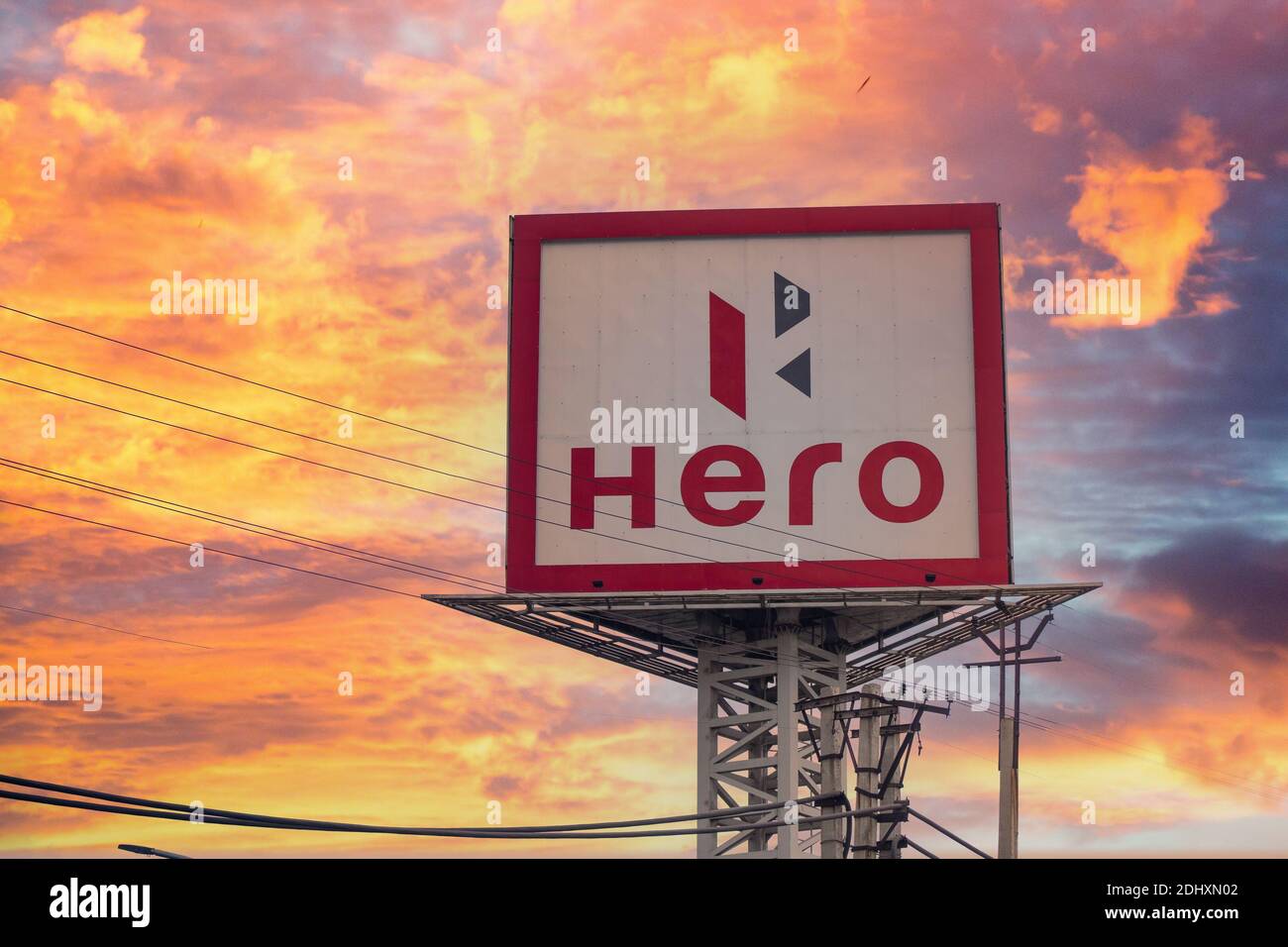 Signage at a hero motors factory shot against a monsoon clouds and blue ...
