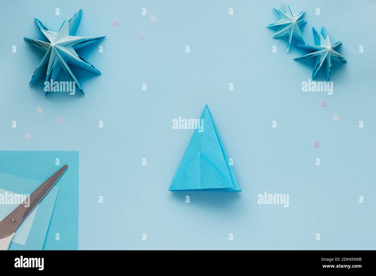 Simple origami 3D Christmas tree made from blue paper. Step by step ...
