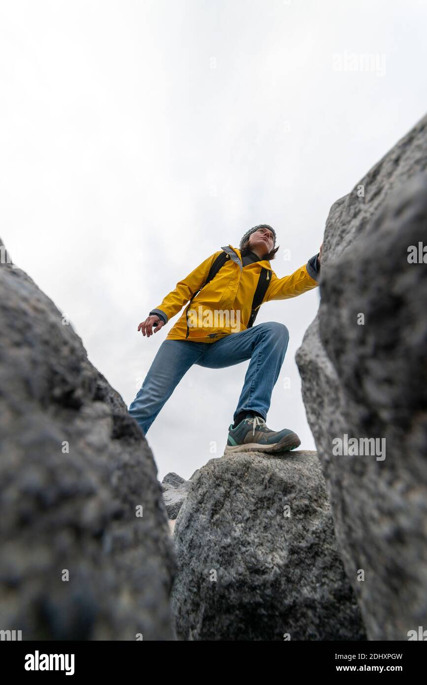 woman hiker climbing over rocks Stock Photo - Alamy