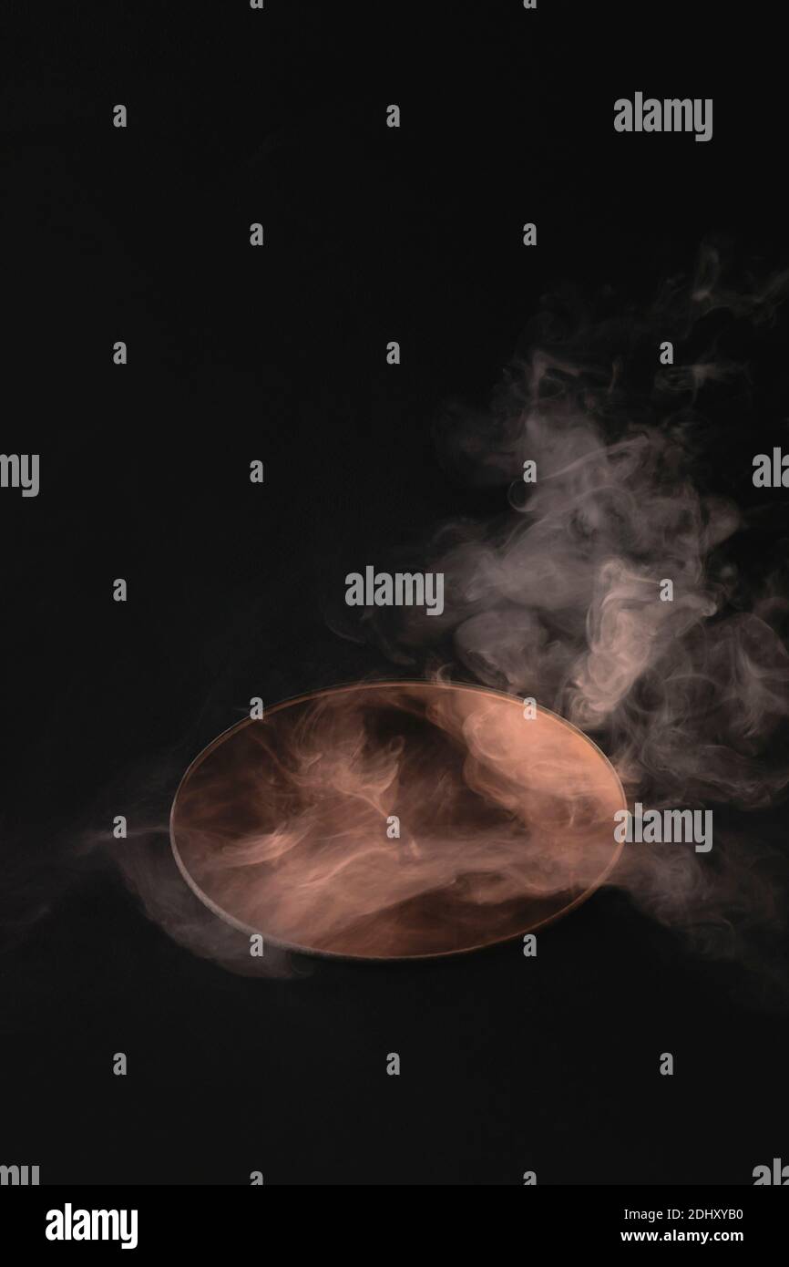 Surreal smoke with reflection in a round mirror Stock Photo - Alamy