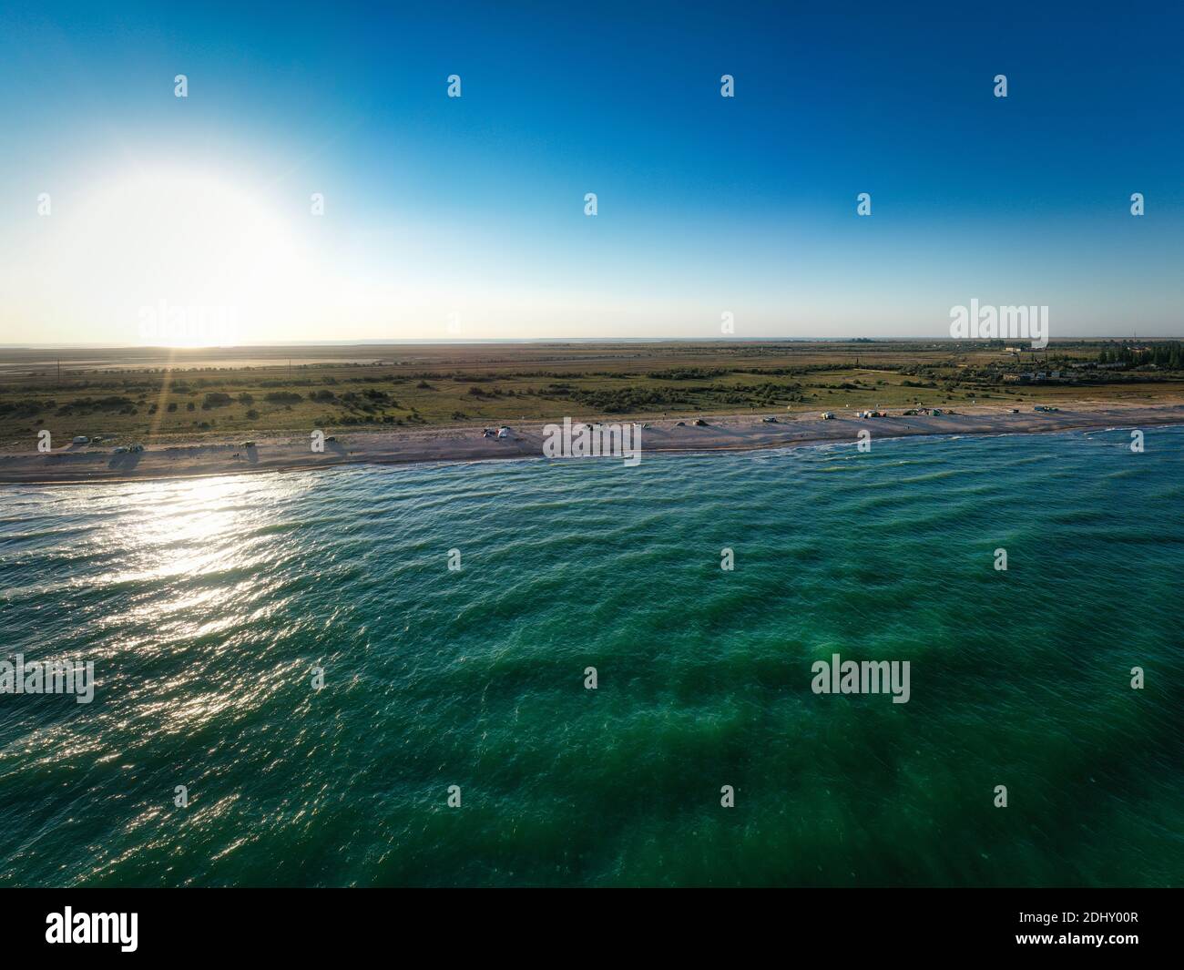 The edge of the sea in the evening sun. Camping beach. Drone shot 4K ...