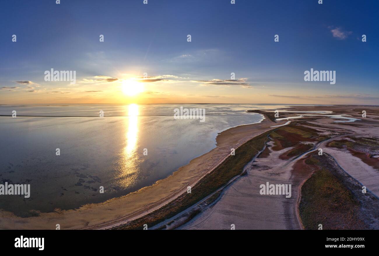 The edge of the sea in the evening sun. Camping beach. Drone shot 4K ...