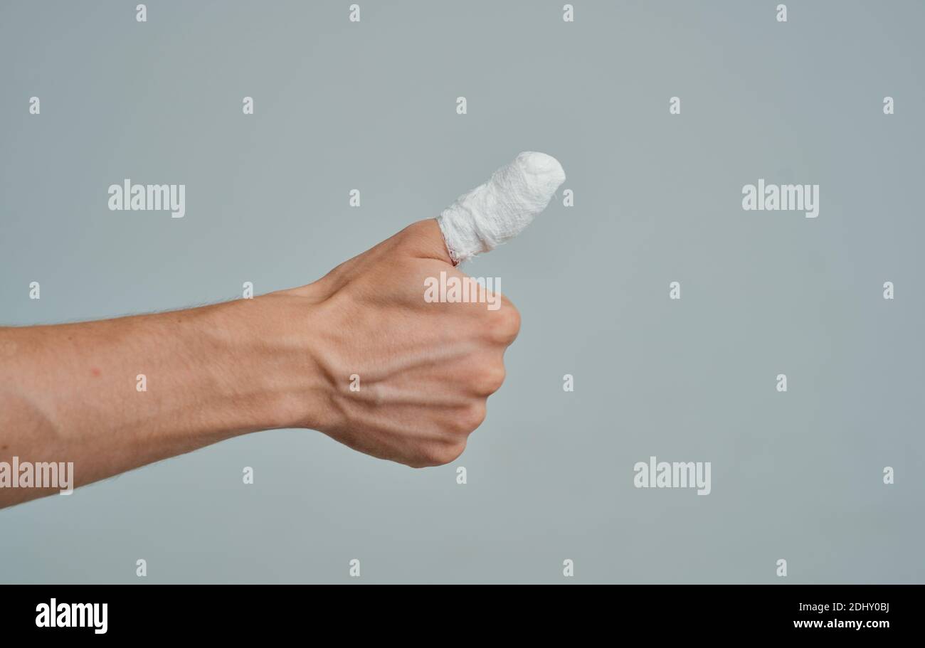 man in white t-shirt broken finger bandaged medicine Stock Photo - Alamy