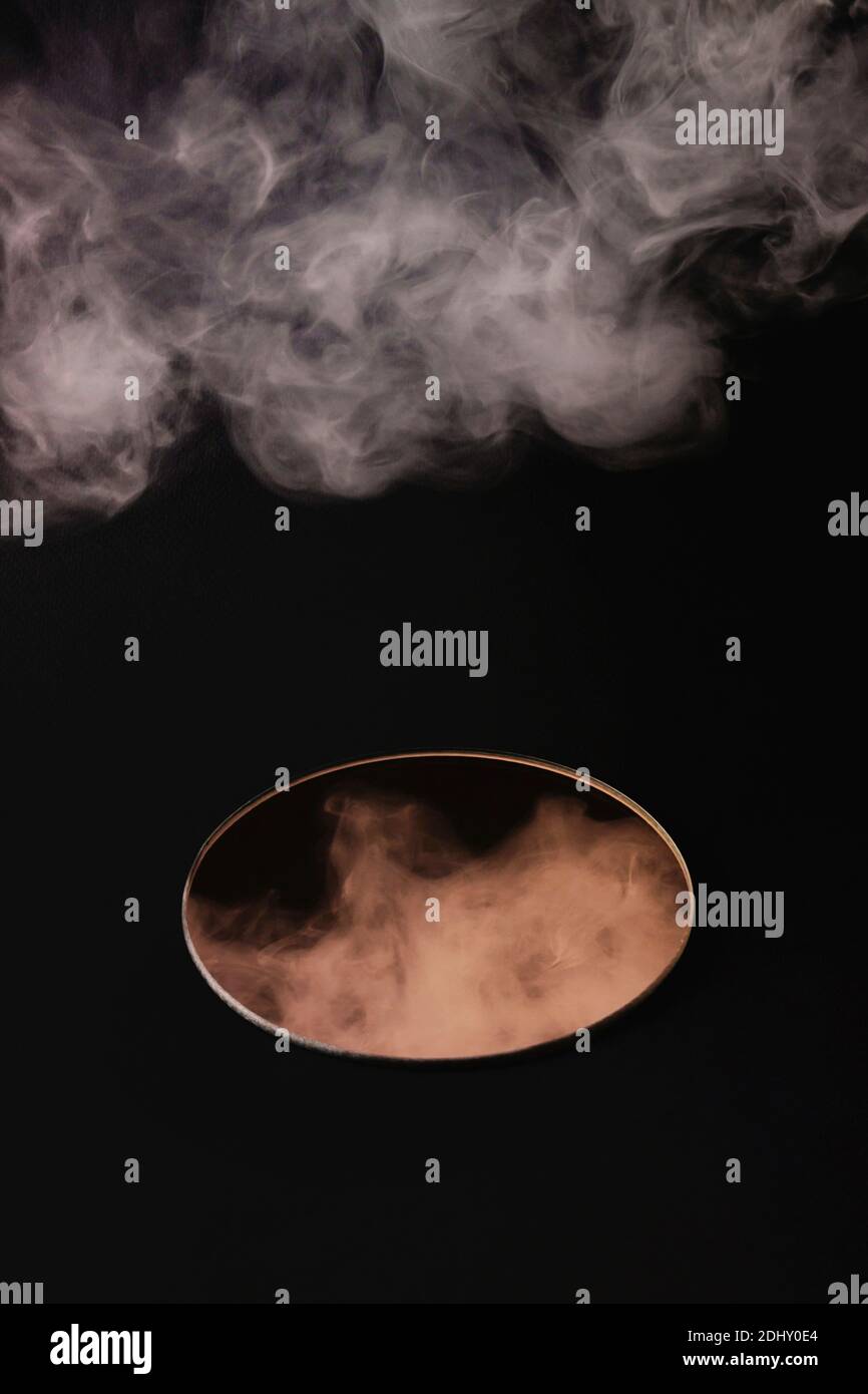 Surreal smoke with reflection in a round mirror Stock Photo - Alamy