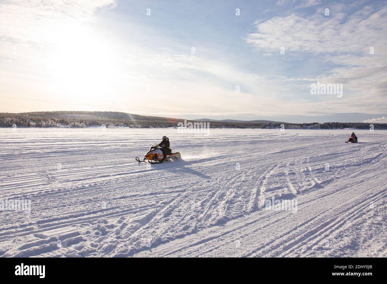 Touristic snowmobile tour on a frozen river in Jukkasjarvi, Kiruna ...