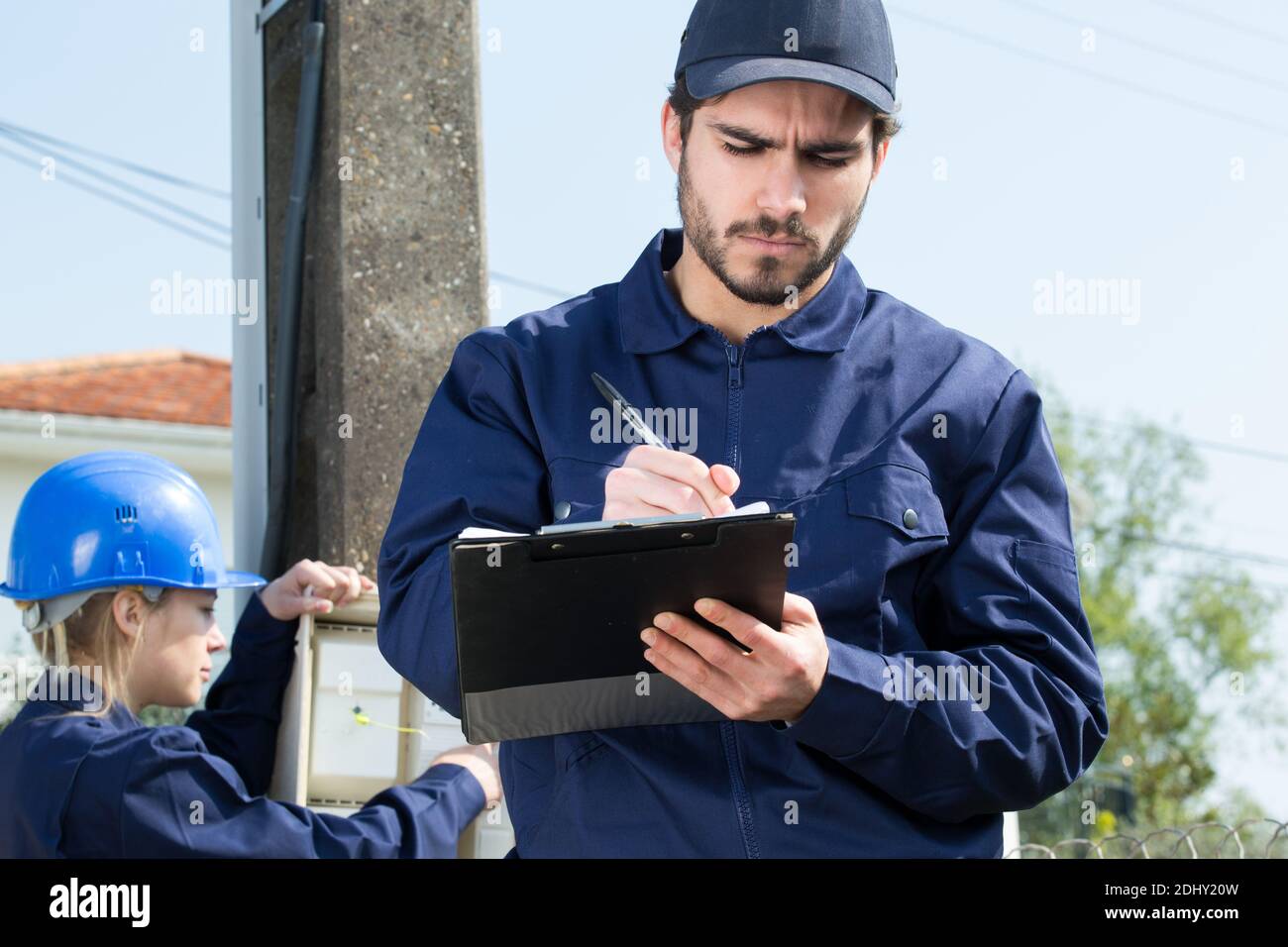 technicians making notes from outdoor electric meter Stock Photo - Alamy