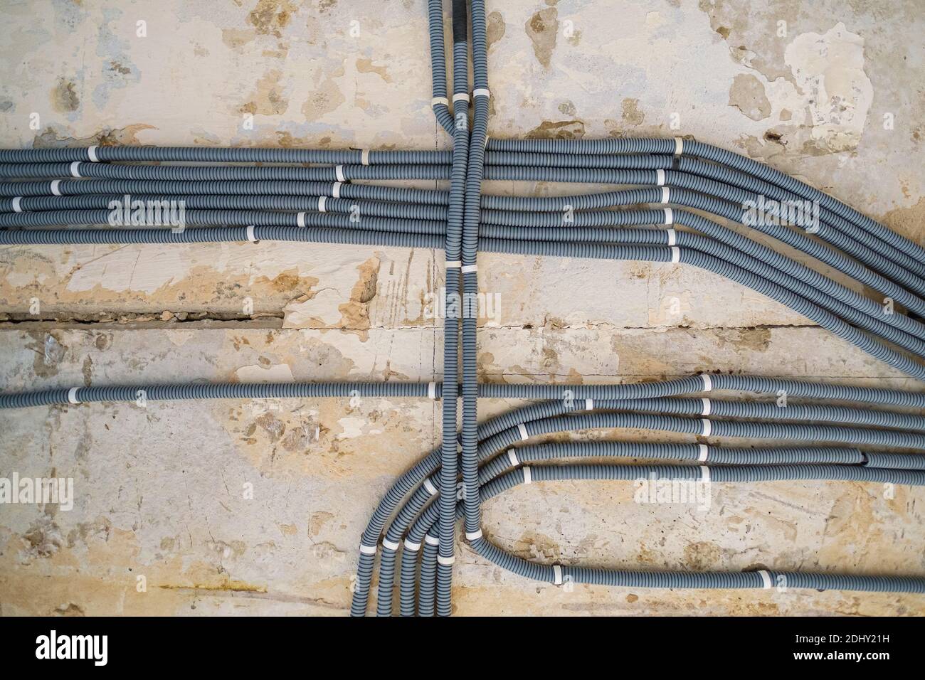 Electric cables in plastic tubes on ceiling, indoor renovation concept ...