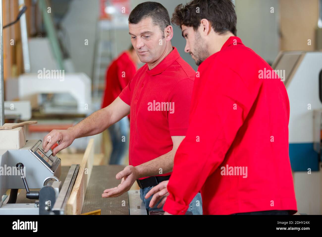 demonstrating the use of a carpentry machine Stock Photo - Alamy