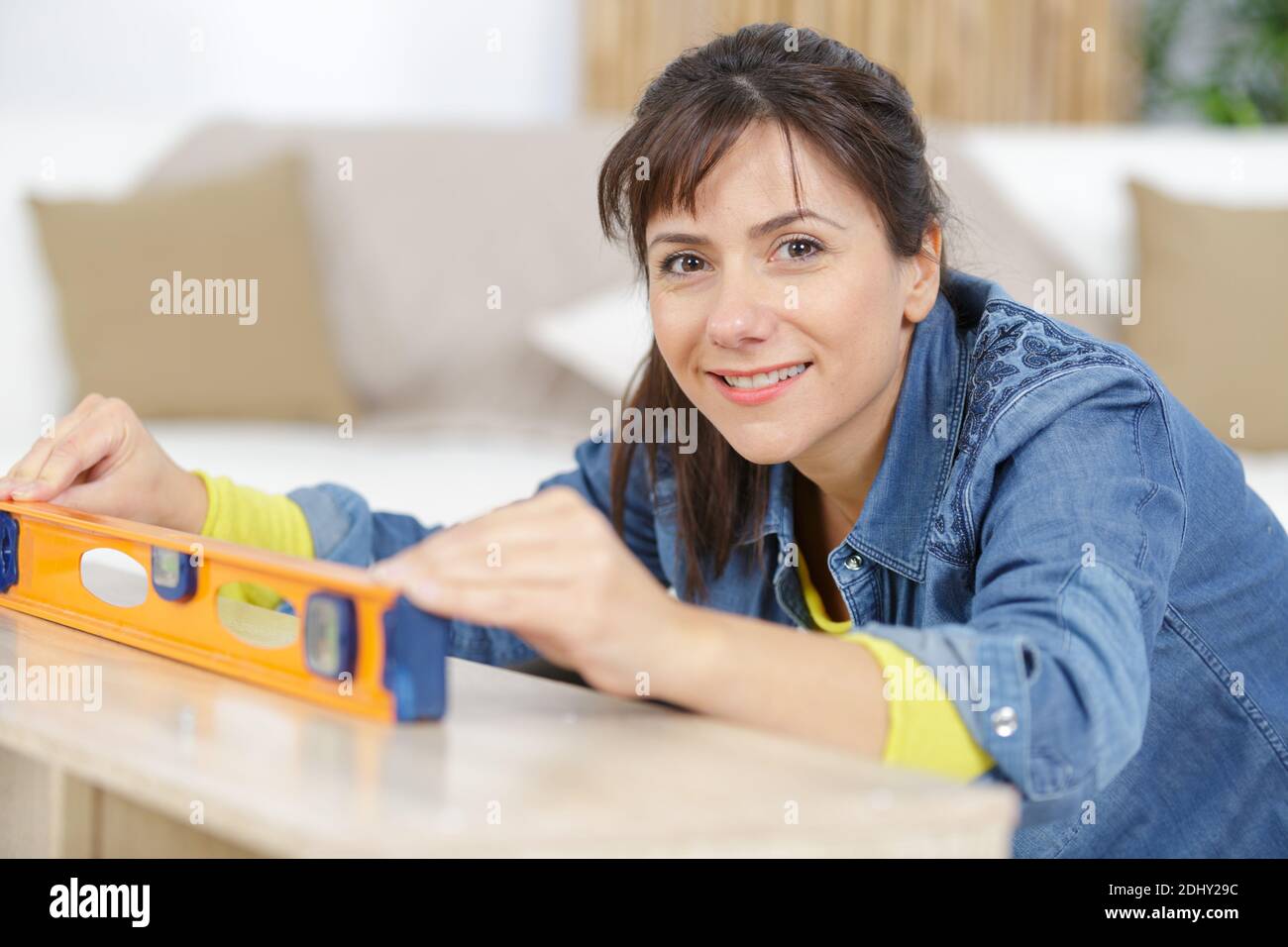 woman using spirit level in the home Stock Photo - Alamy