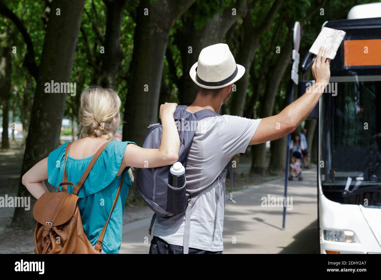 a couple stopping a bus Stock Photo - Alamy