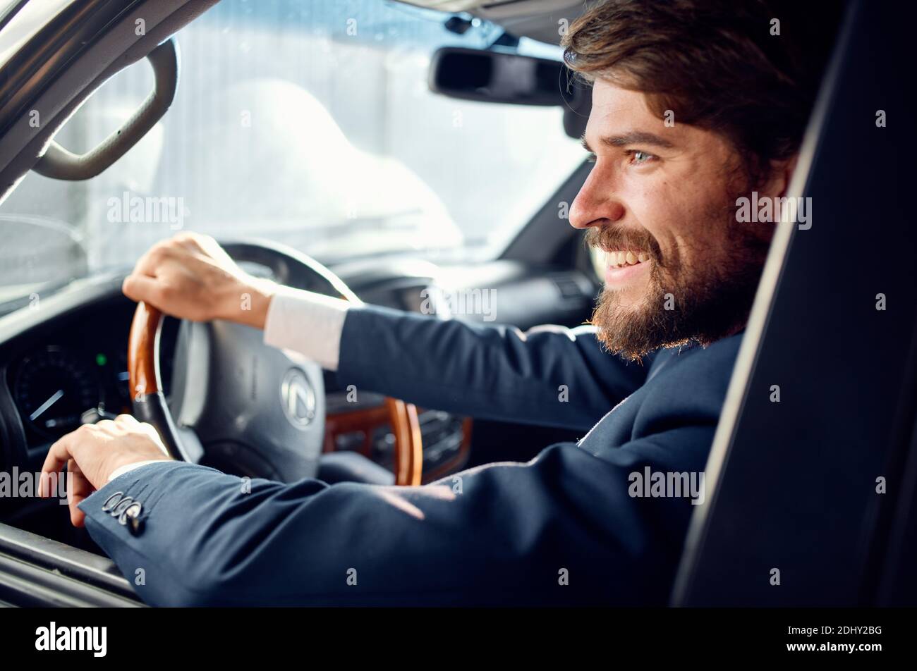 man driving a car trip road official wealth Stock Photo - Alamy
