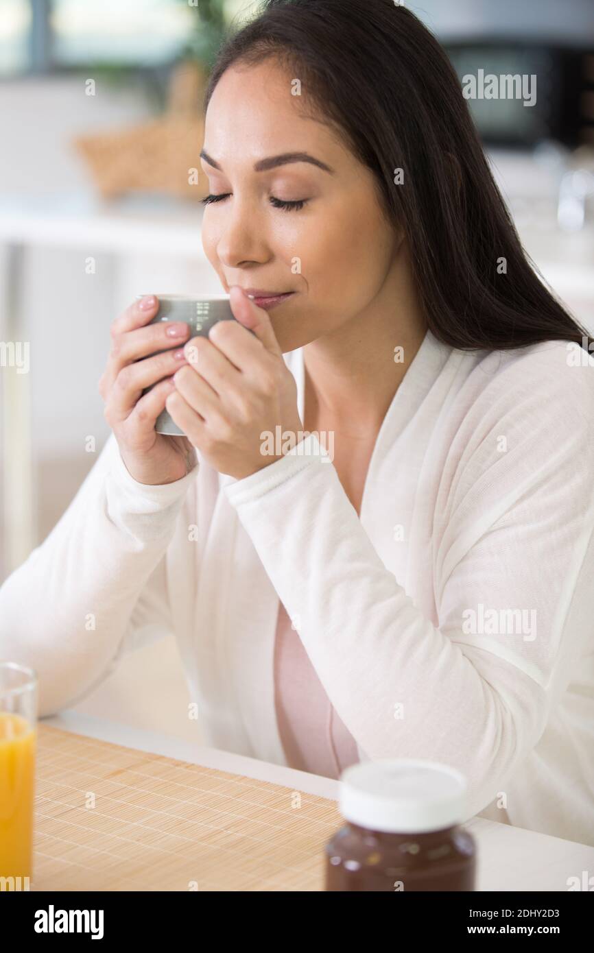 beautiful woman is smelling coffee Stock Photo - Alamy