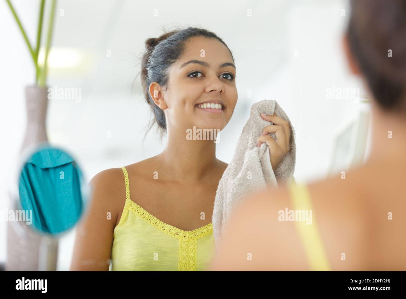 smiling young woman drying face Stock Photo - Alamy