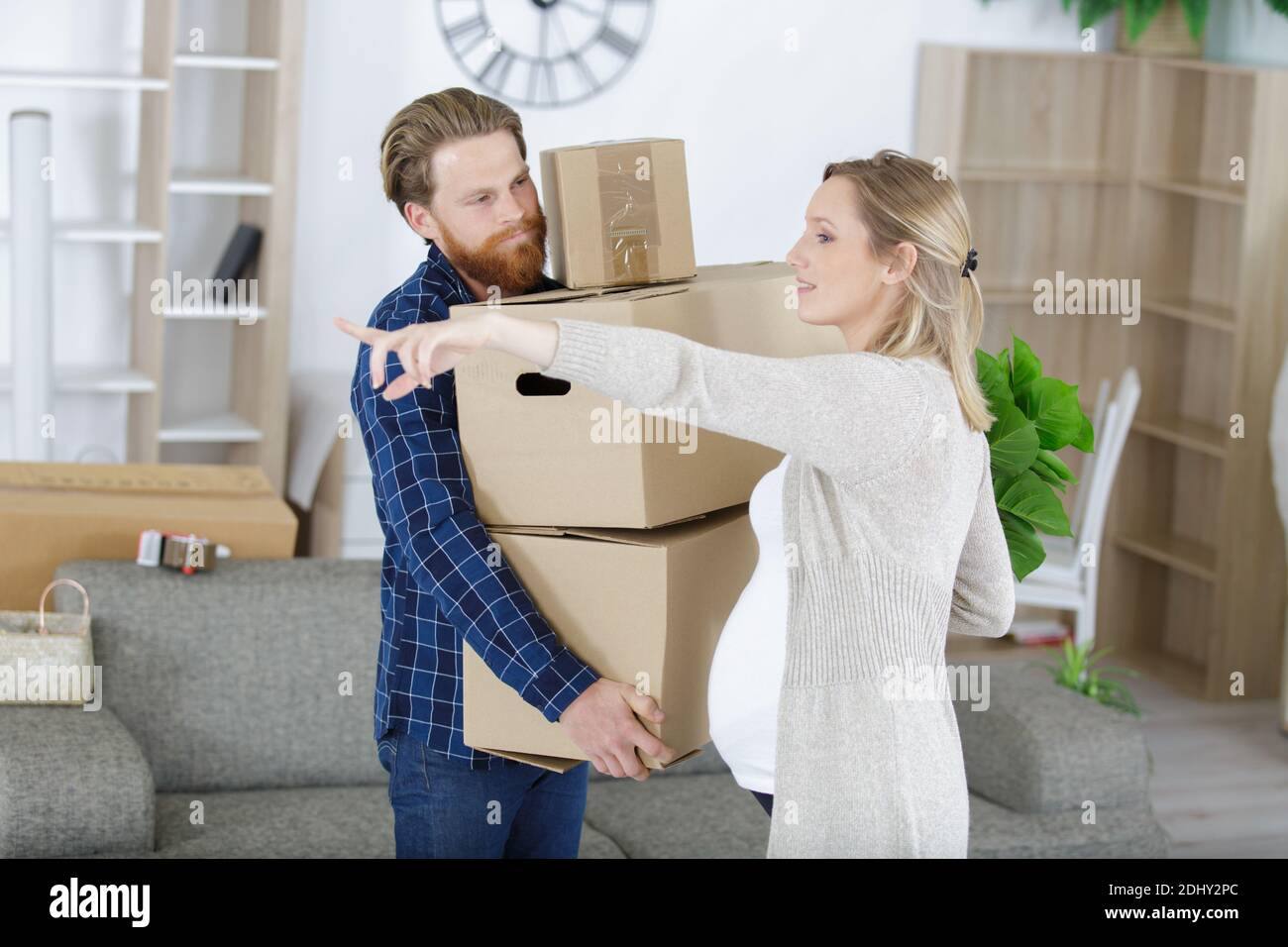 she is pointing at where to put the box Stock Photo - Alamy