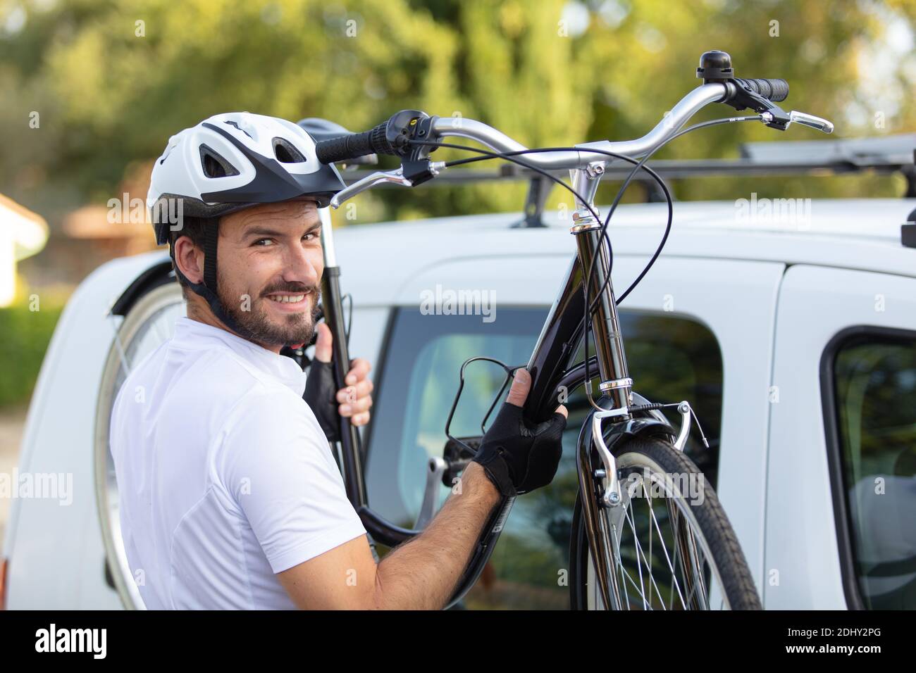 biker man take of his bike from the car roof Stock Photo - Alamy