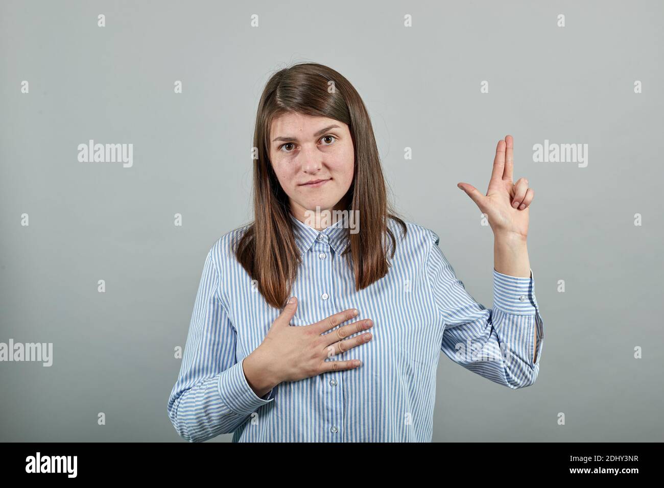 Handsome with hand on chest and fingers up, making a loyalty promise ...