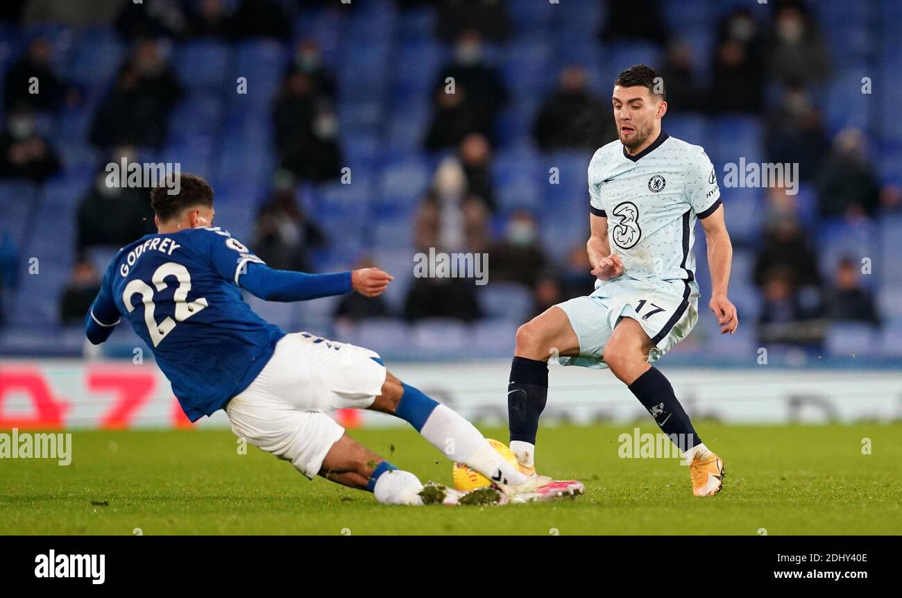 Everton's Ben Godfrey (left) slides in on Chelsea's Mateo Kovacic ...