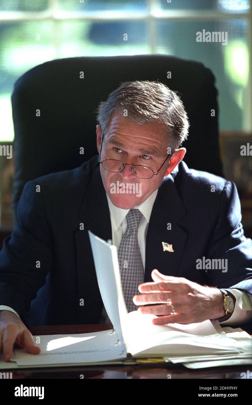 Working at his desk in the Oval Office of the White House in Washington ...