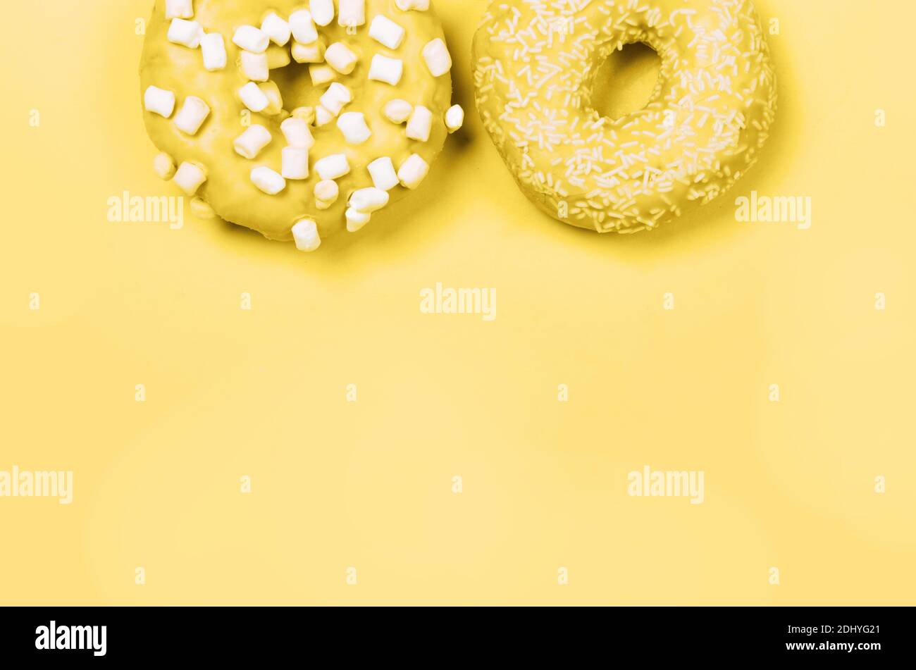 Colors of year 2021. Gray and Yellow. Two donuts with icing on pastel ...