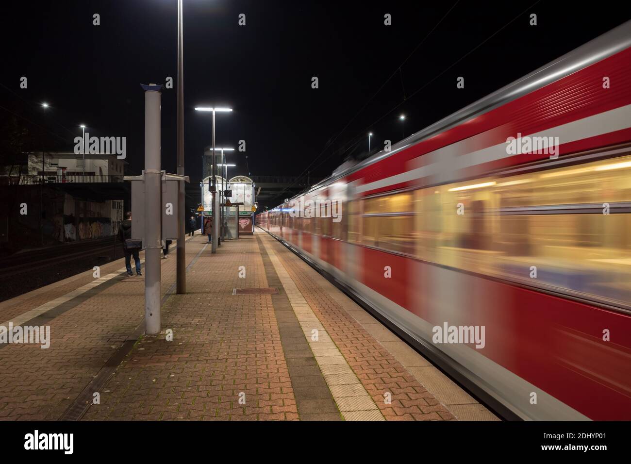 Night outdoor scenery of platform railway station and regional train ...