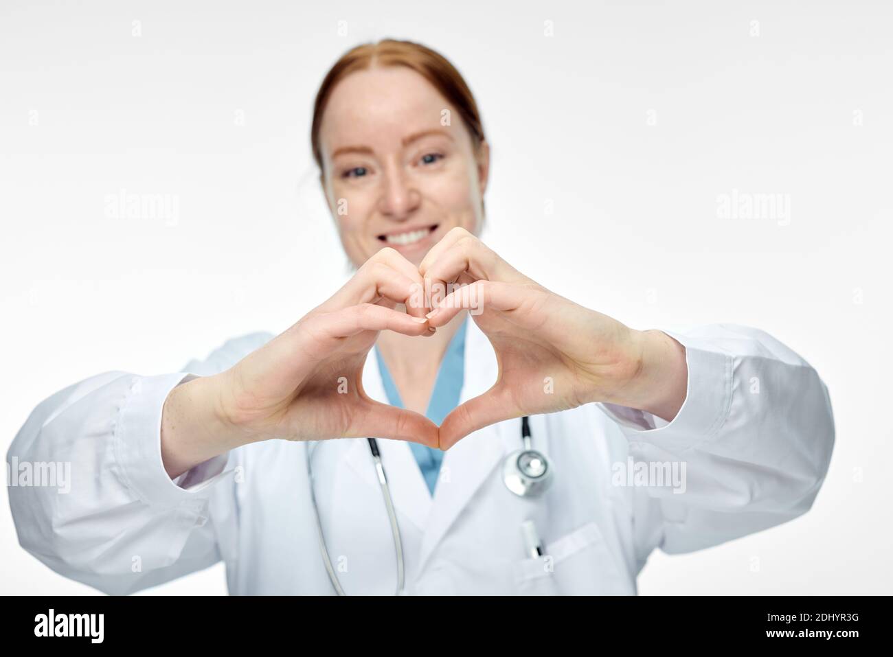 young smiling female doctor making heart sign with her hands Stock ...