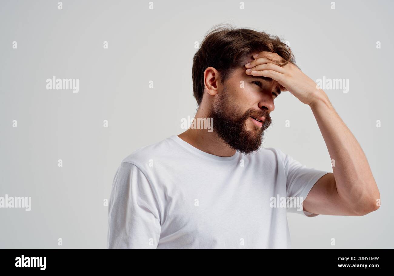 bearded man holding his head pain health problems close-up Stock Photo ...