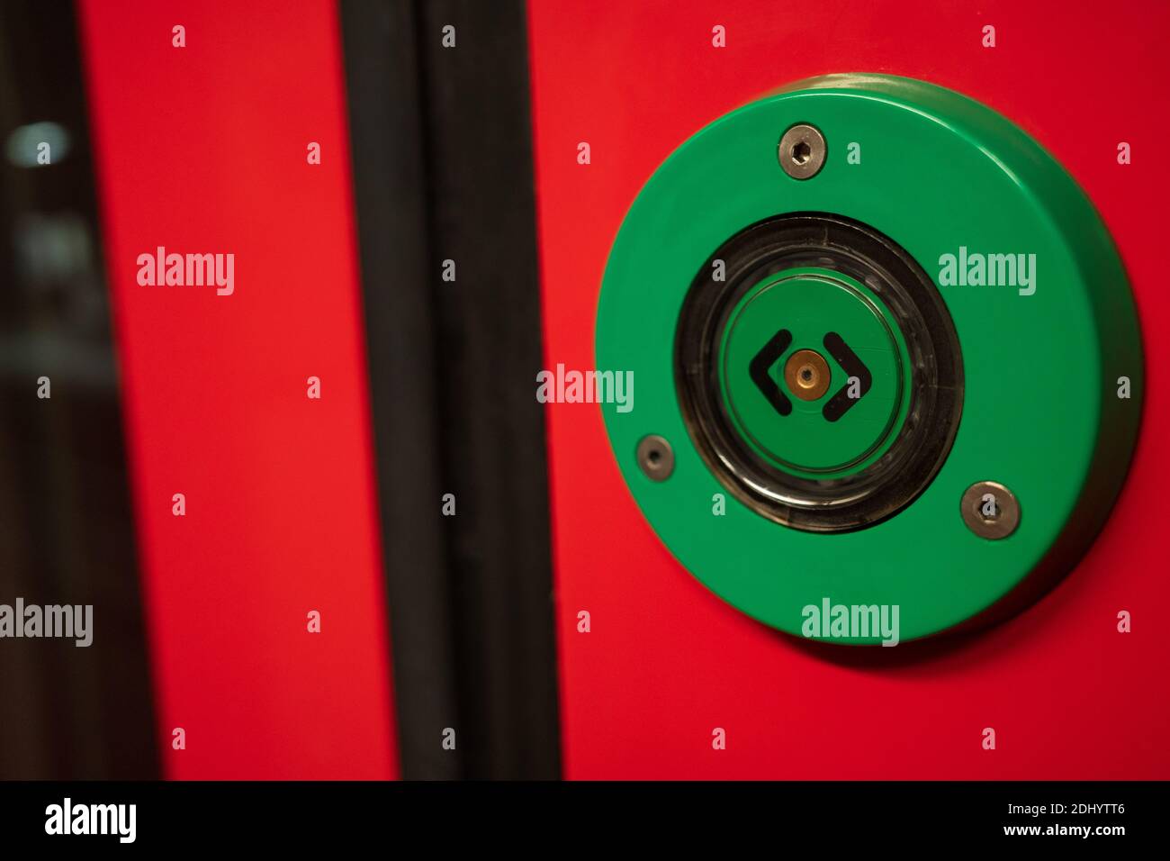Close-up view at Green Push button for open the door on train's door of ...