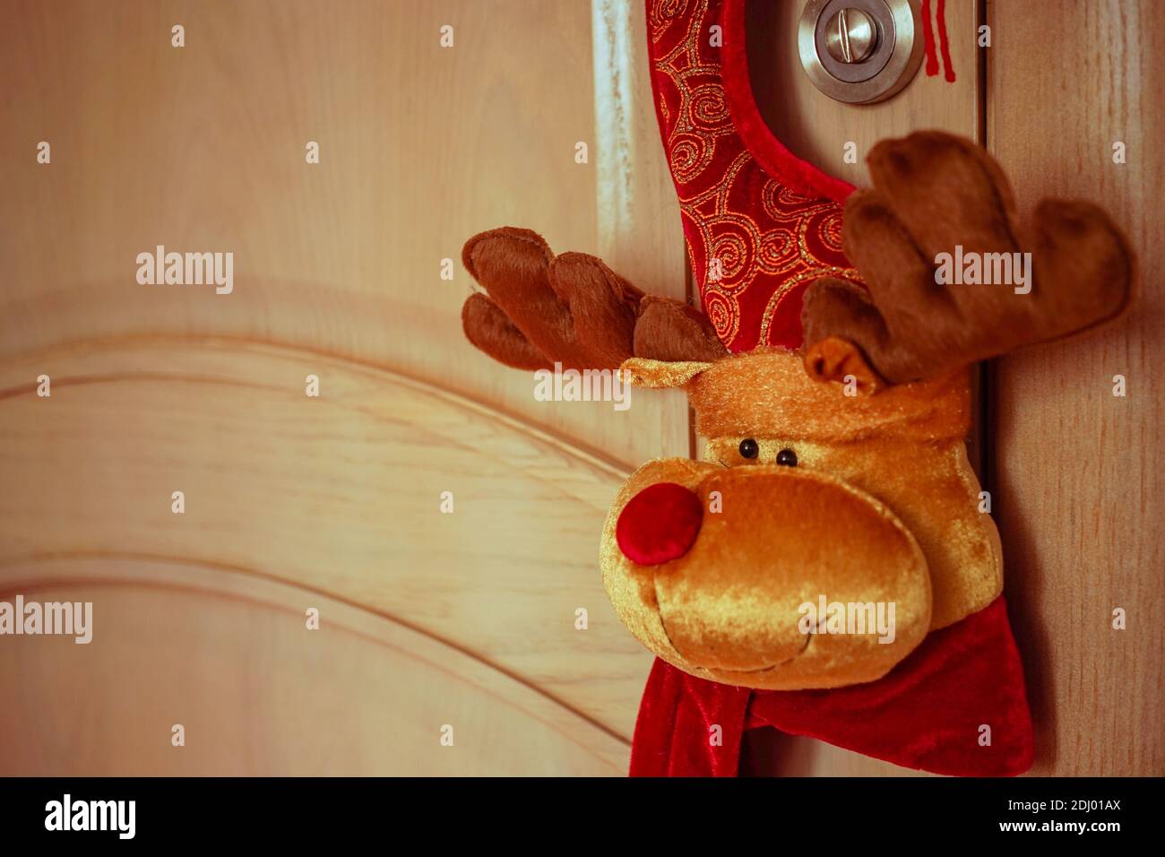 Soft toy beer with horns hang on the door handle Stock Photo - Alamy