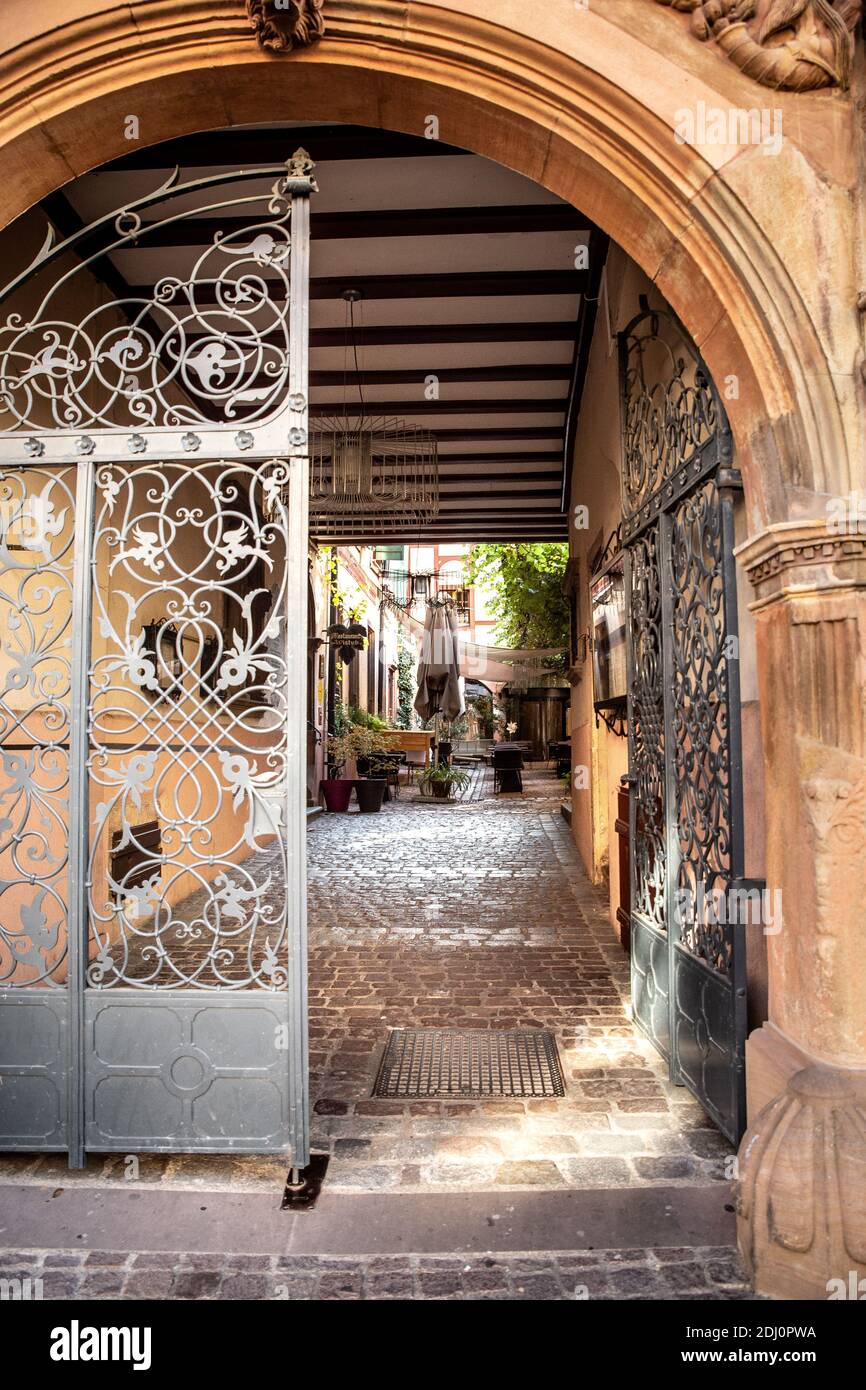 Ornate gate leading to courtyard restaurant, France Stock Photo - Alamy