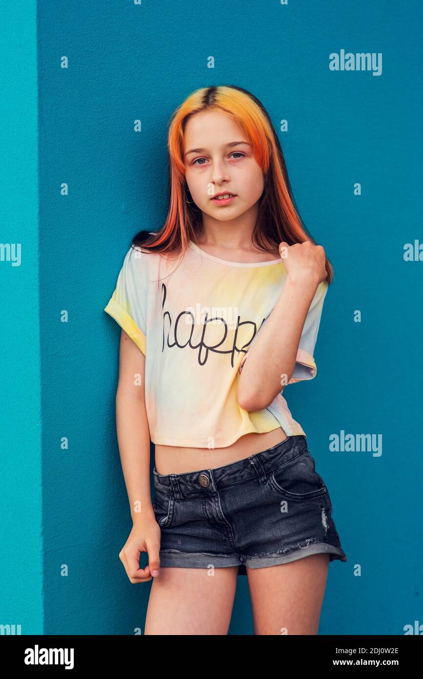 Beautiful girl of school age with fashionable hair coloring. Positive ...