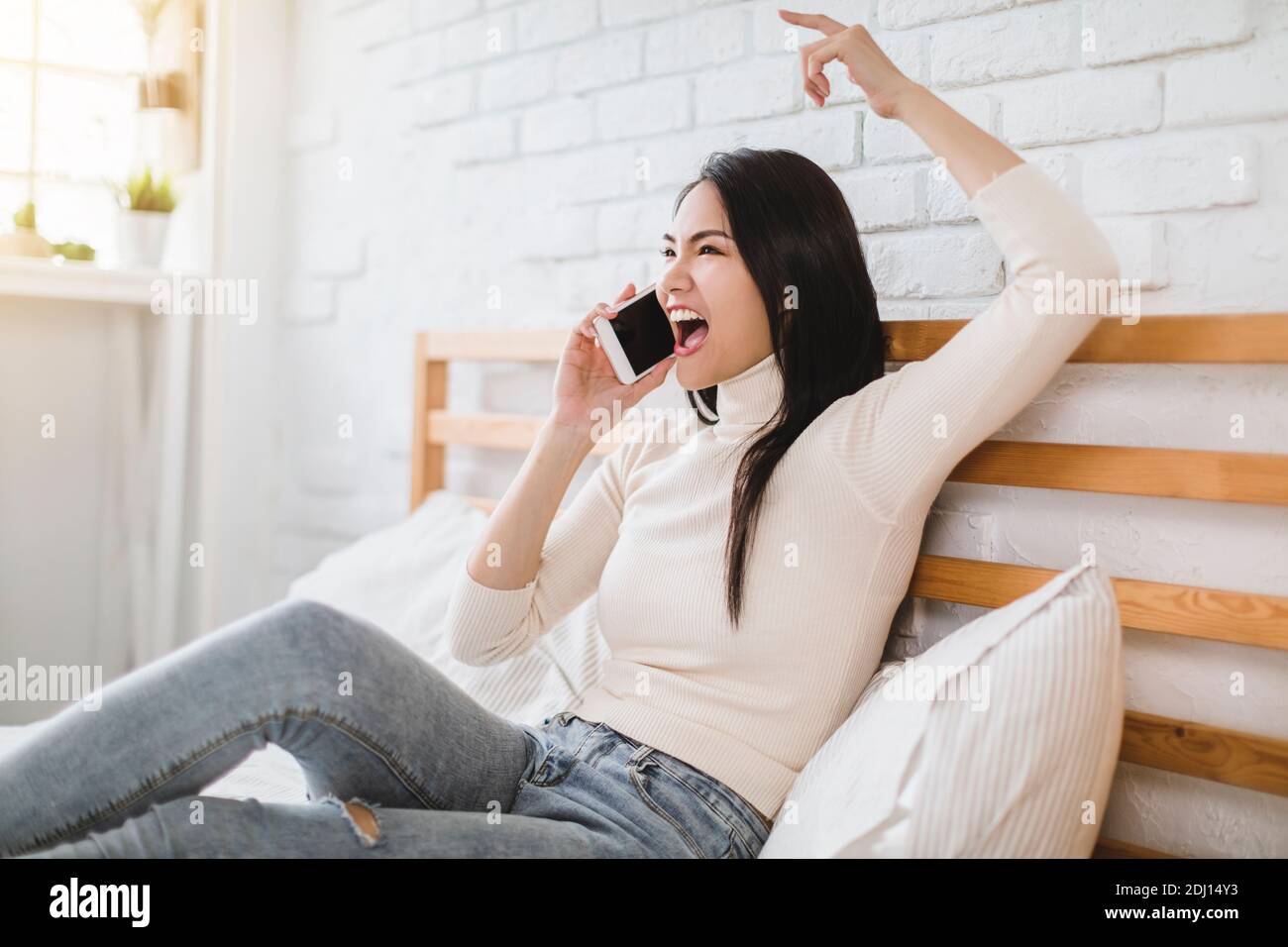 angry young woman talking with friend on mobile phone Stock Photo - Alamy