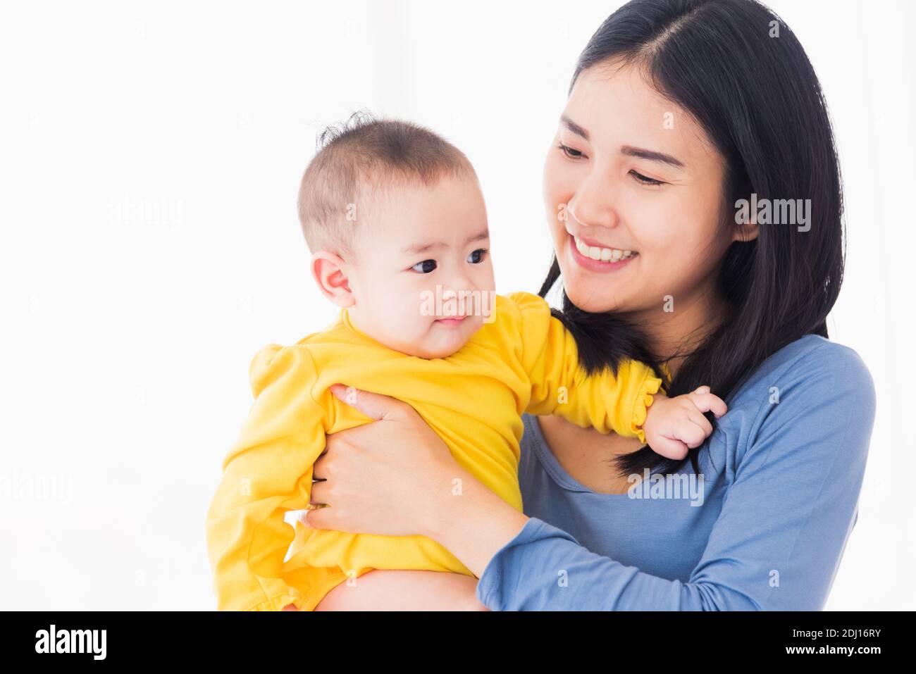 Portrait of beautiful young Asian mother holding his newborn little ...