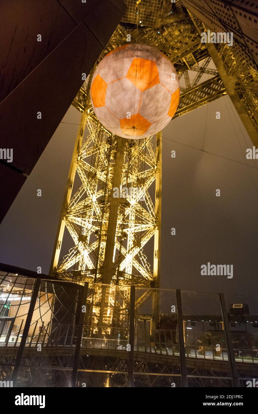 An inflated ball hung inside the Eiffel Tower next to the under ...